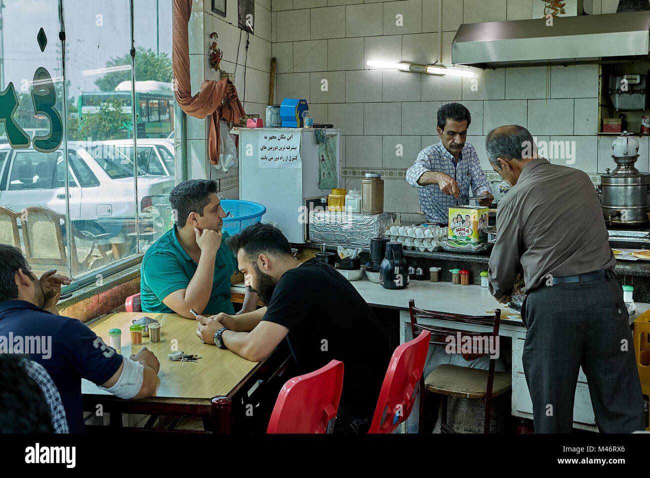 Tehran, Iran - April 28, 2017: Iranian man giving food to local ...