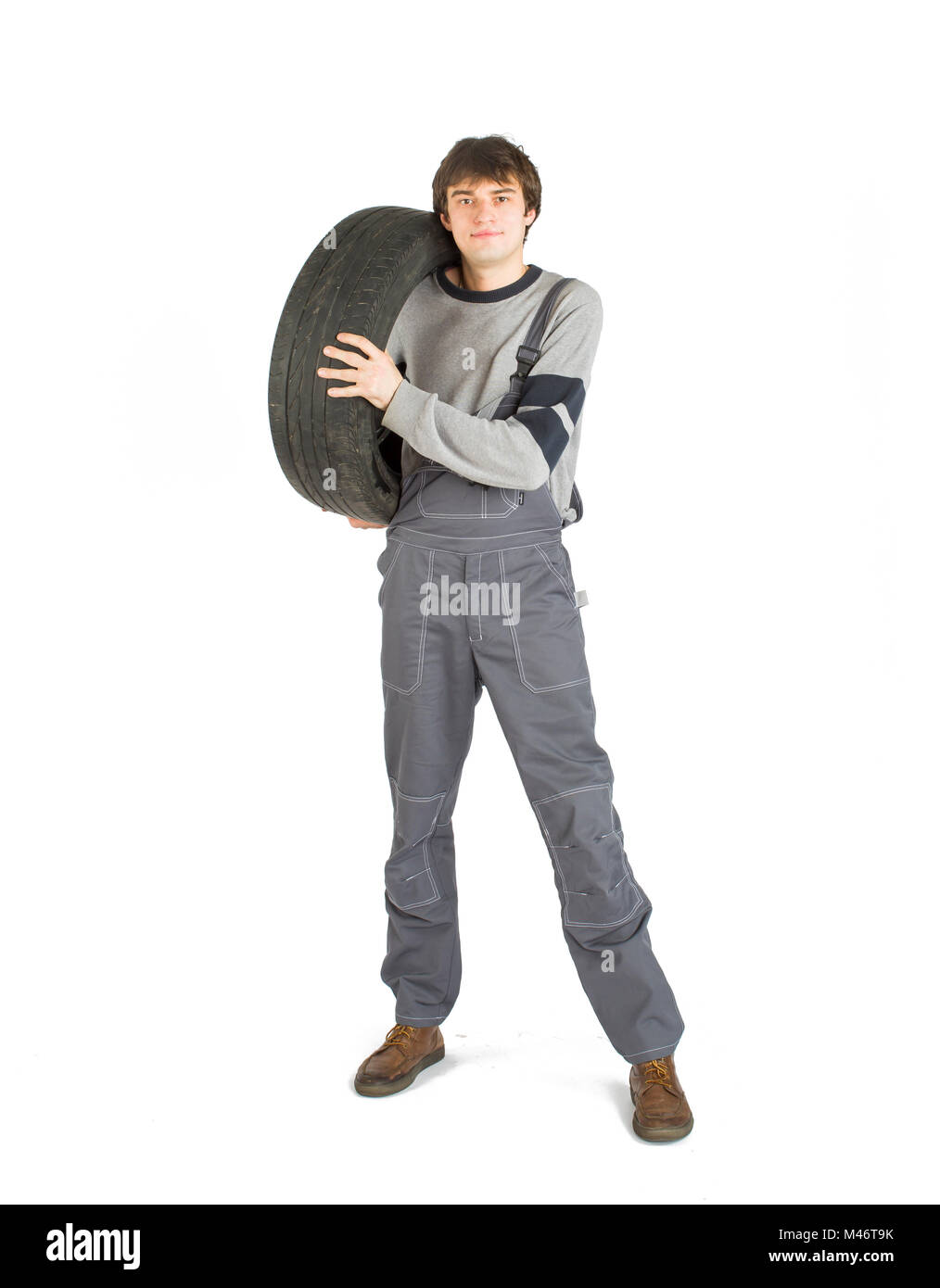 A young brunet foreman in working grey uniform with black wheel Stock ...
