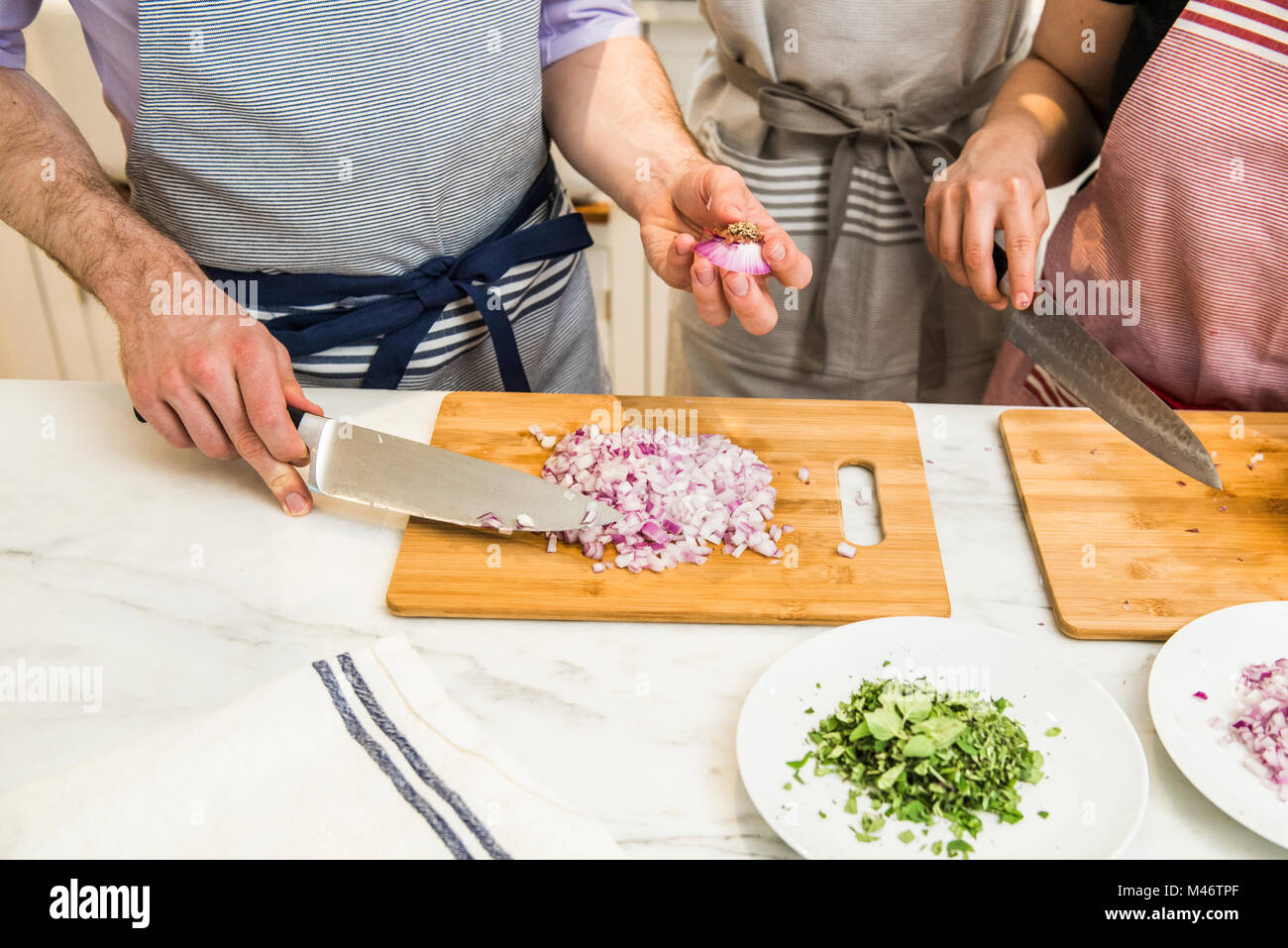 Learning knife skills together Stock Photo - Alamy