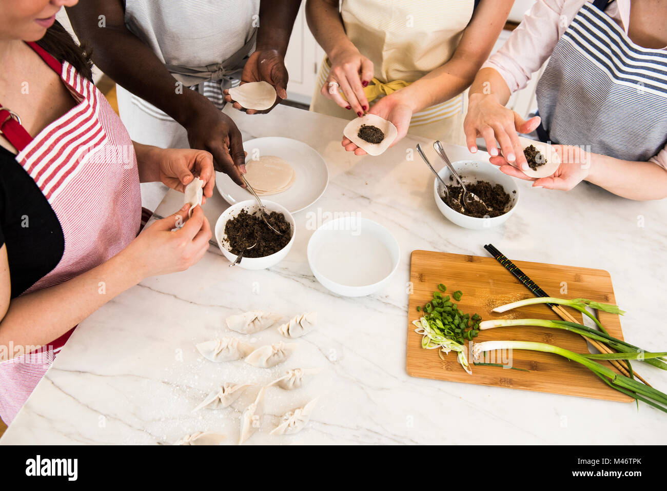 Learning how to make dumplings together Stock Photo - Alamy