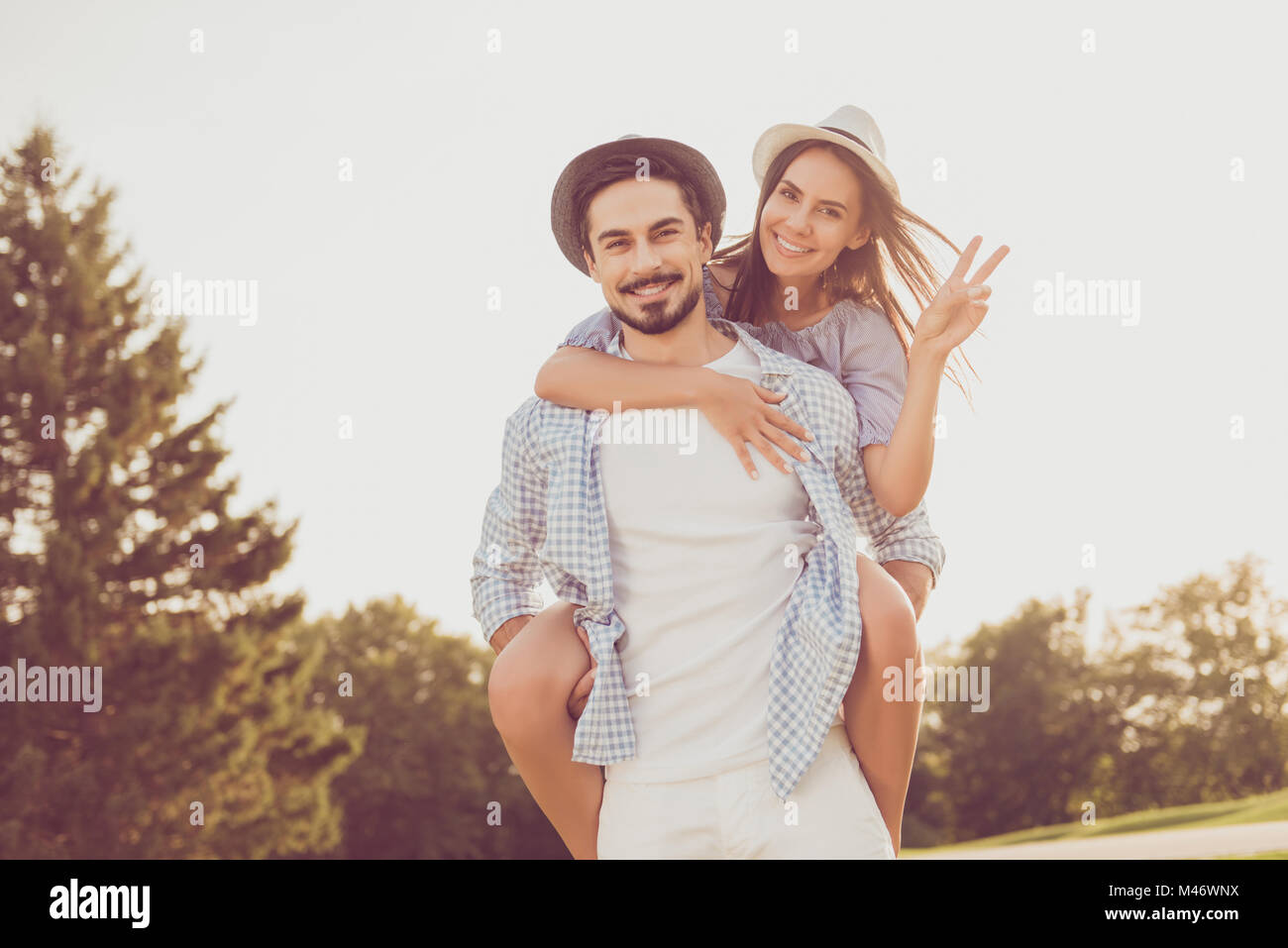 Attractive cute sweet partner piggybacking his gorgeous lady, she ...