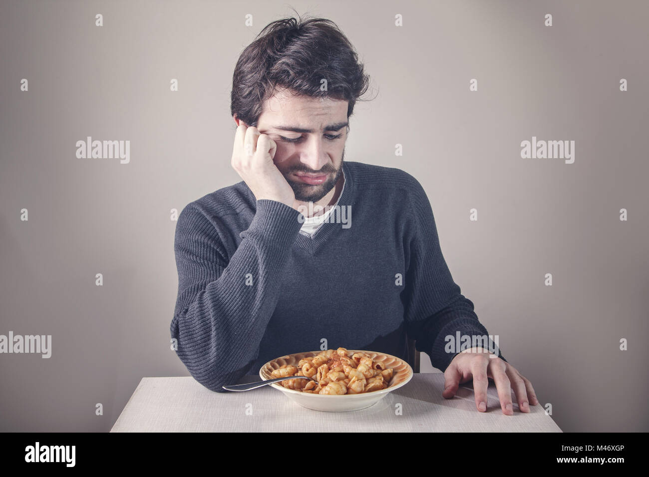 Young man is not hungry Stock Photo - Alamy