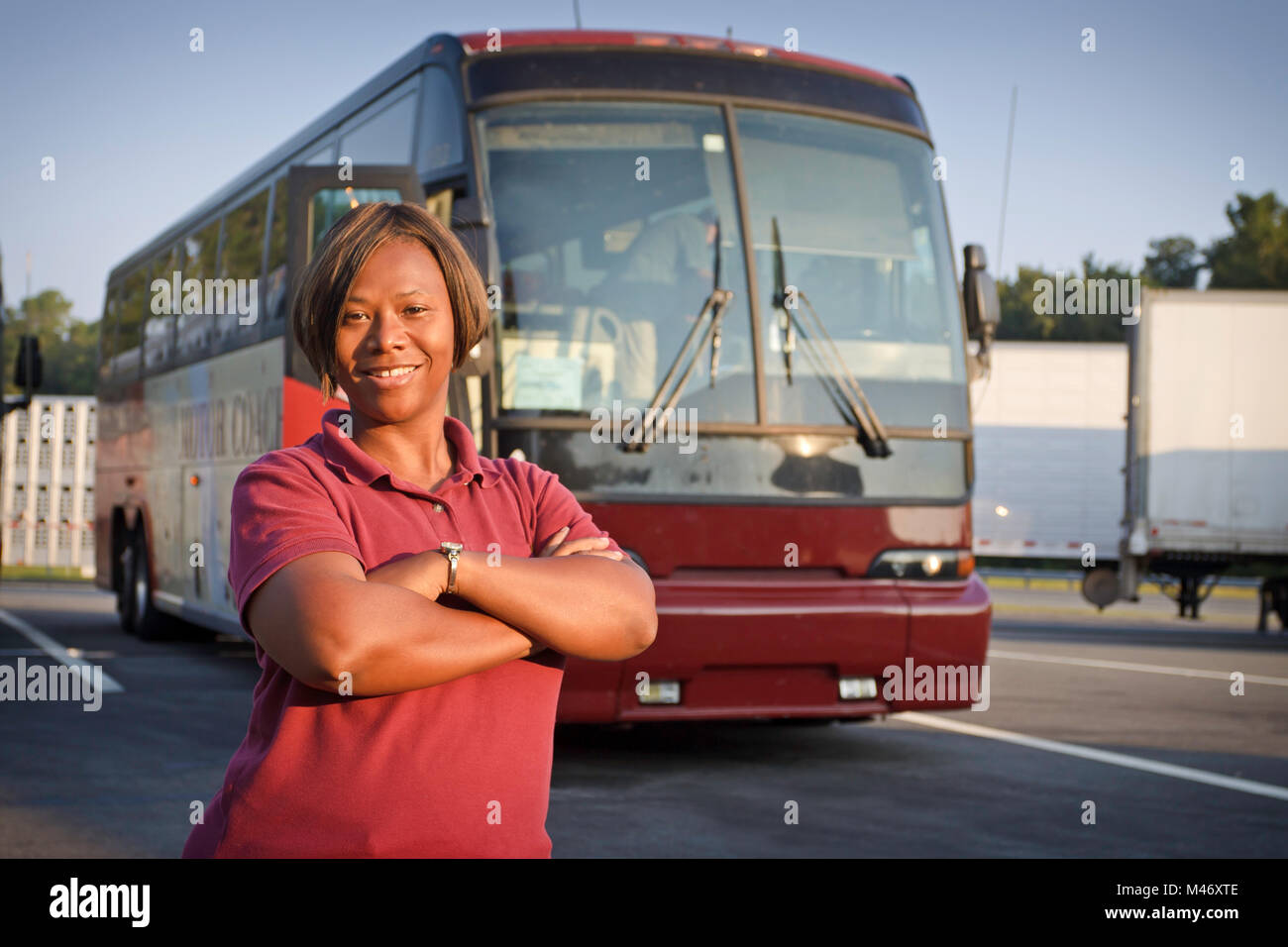 Bus driver standing in front of her tour bus Stock Photo - Alamy
