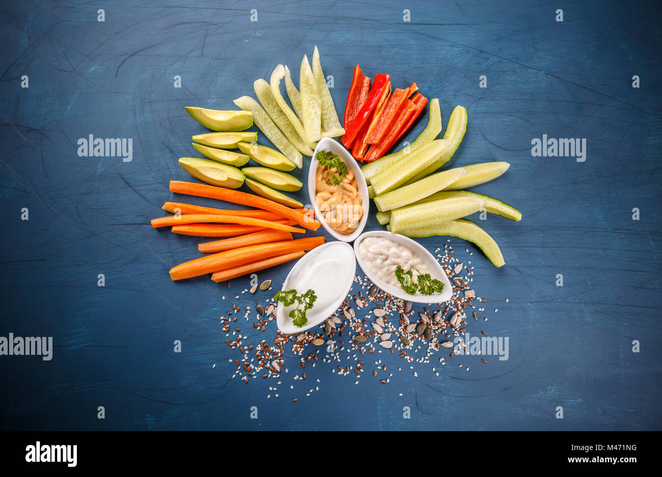Vegetarian healthy snacks with dips on blue background Stock Photo - Alamy