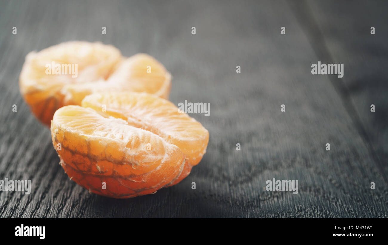 ripe tangerine peeled on wood table Stock Photo - Alamy