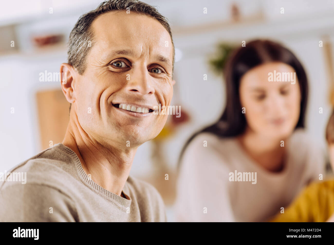 Close up of charming young man posing in kitchen Stock Photo - Alamy