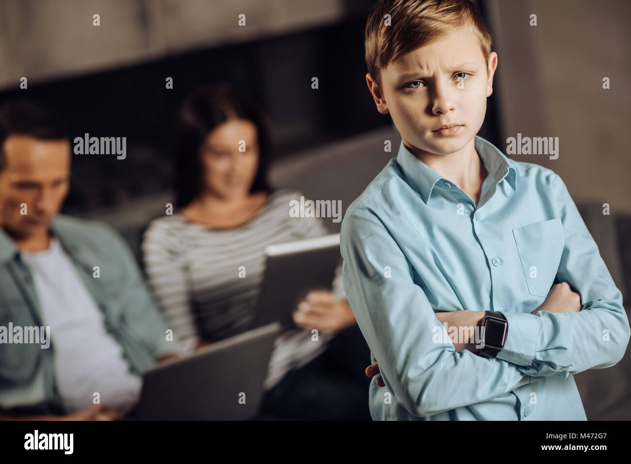 Pre-teen boy being sad about lack of parents attention Stock Photo - Alamy