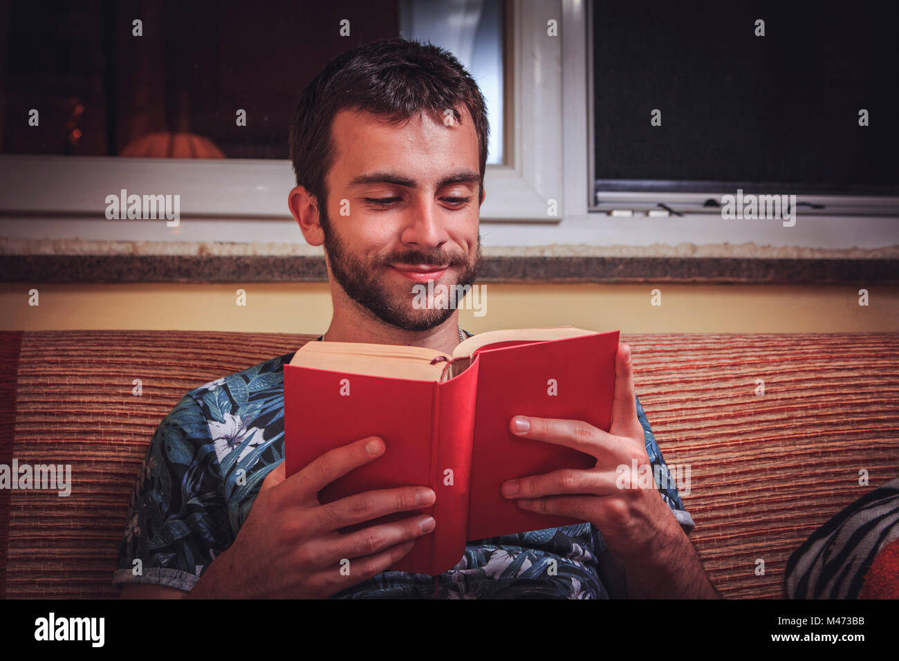 Reading a great book Stock Photo - Alamy
