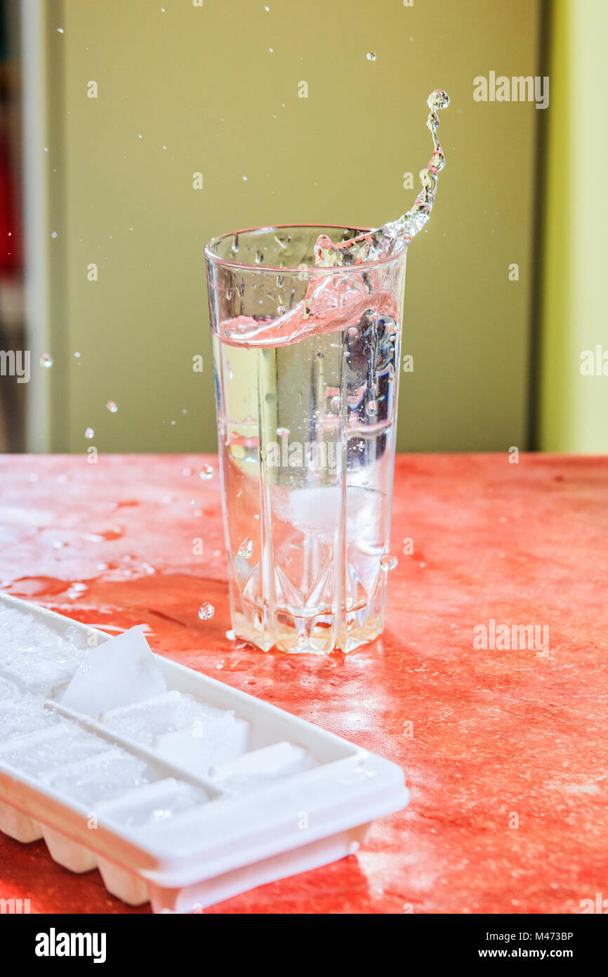 Splash of water in kitchen glass Stock Photo - Alamy