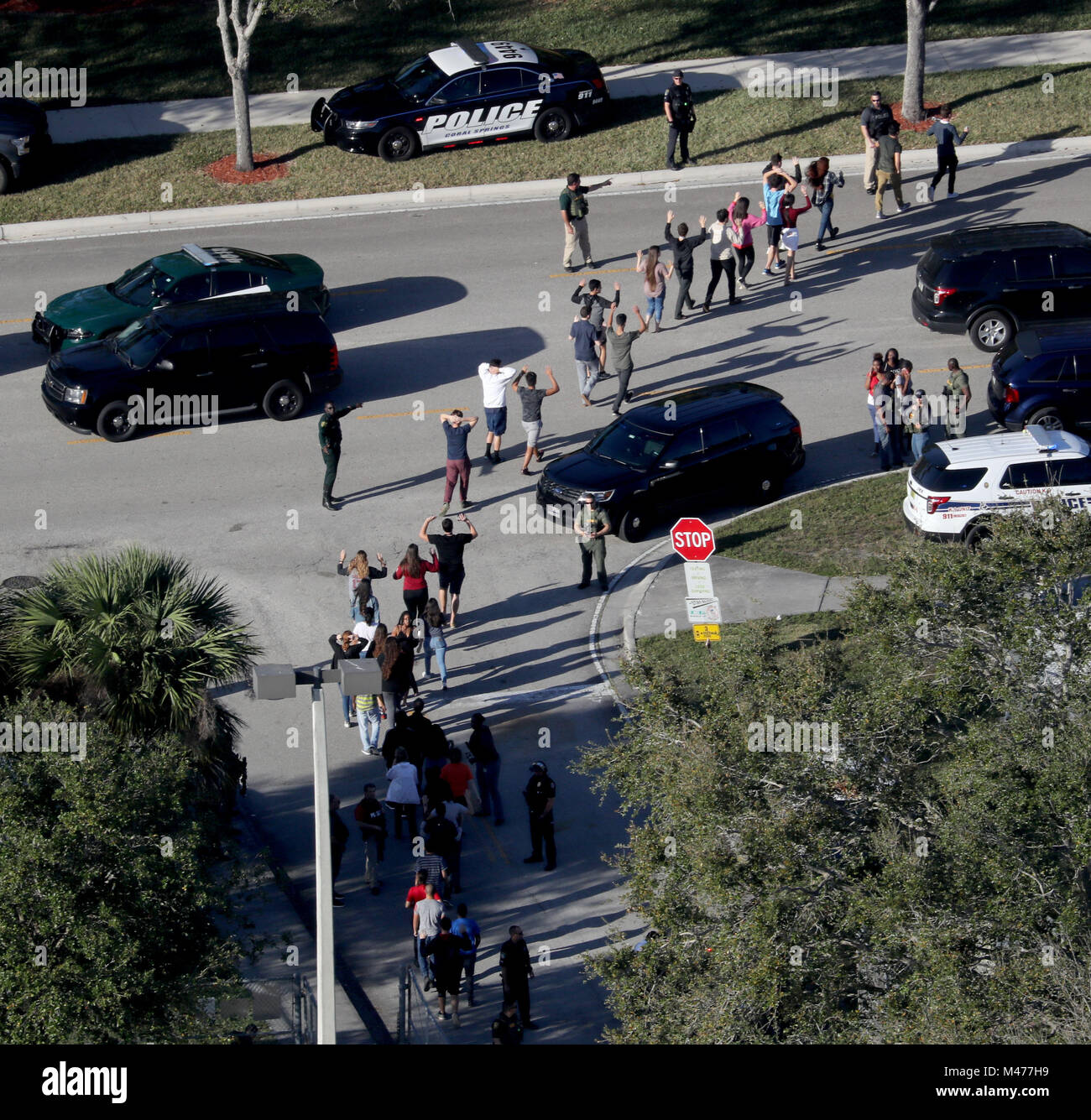Parkland, FL, USA. 16th Feb, 2018. Students are evacuated by police out ...