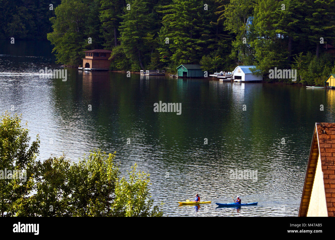 Star Lake, New York, USA. 23rd Aug, 2015. Two canoeists paddle along ...