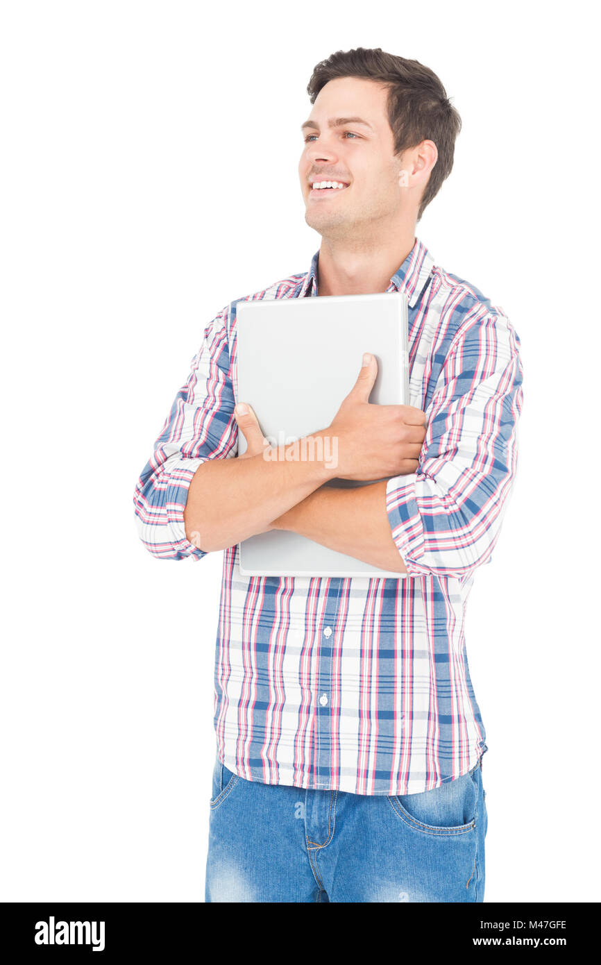 Portrait of smiling male student holding a laptop Stock Photo - Alamy