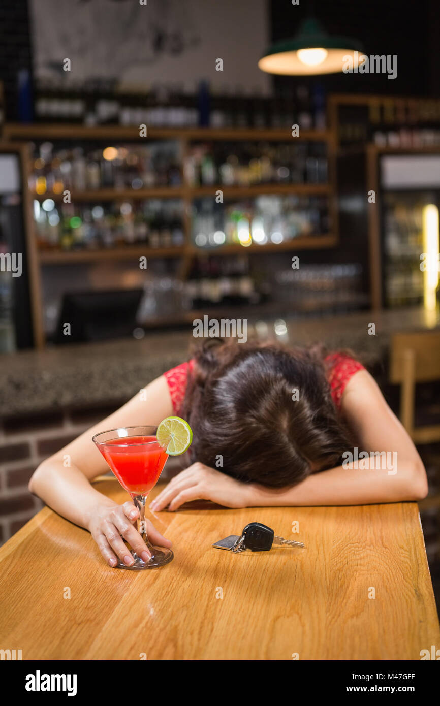 Drunk woman driver leaning on counter with her cocktail Stock Photo - Alamy
