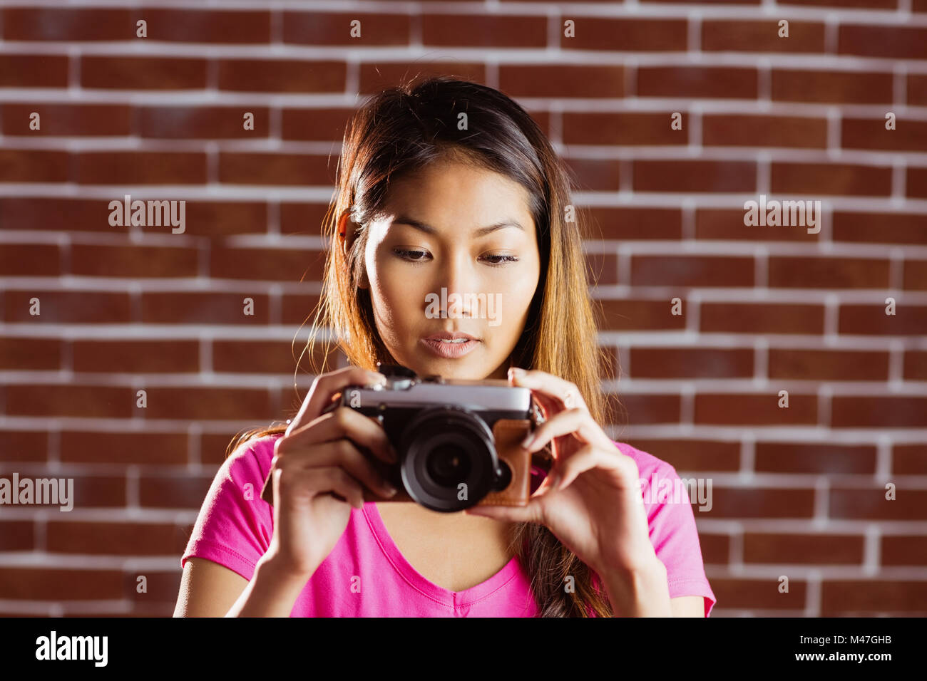 Smiling asian woman taking picture with camera Stock Photo - Alamy