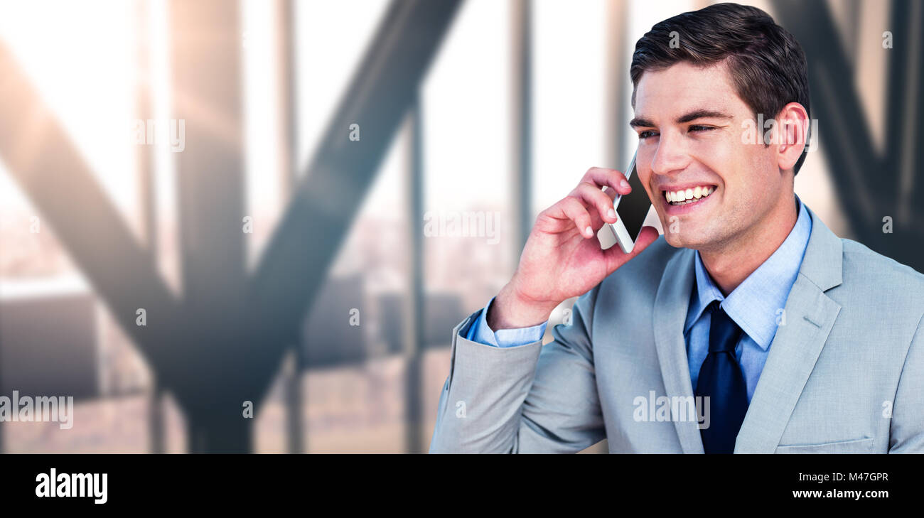 Composite image of smiling businessman using mobile phone Stock Photo ...
