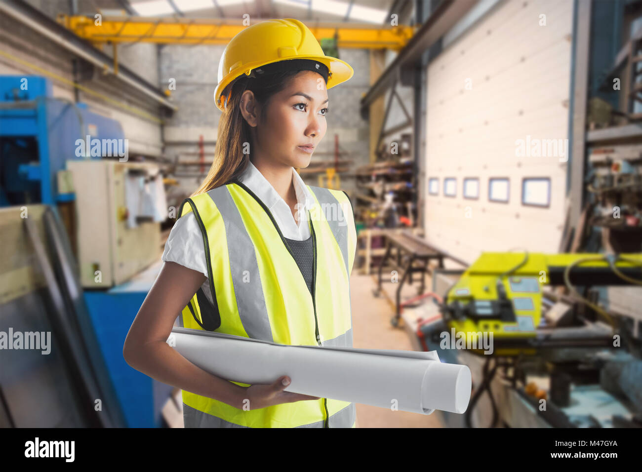 Composite image of serious pretty architect posing Stock Photo - Alamy