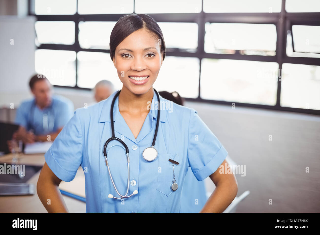 Portrait of happy female doctor smiling in conference room Stock Photo ...