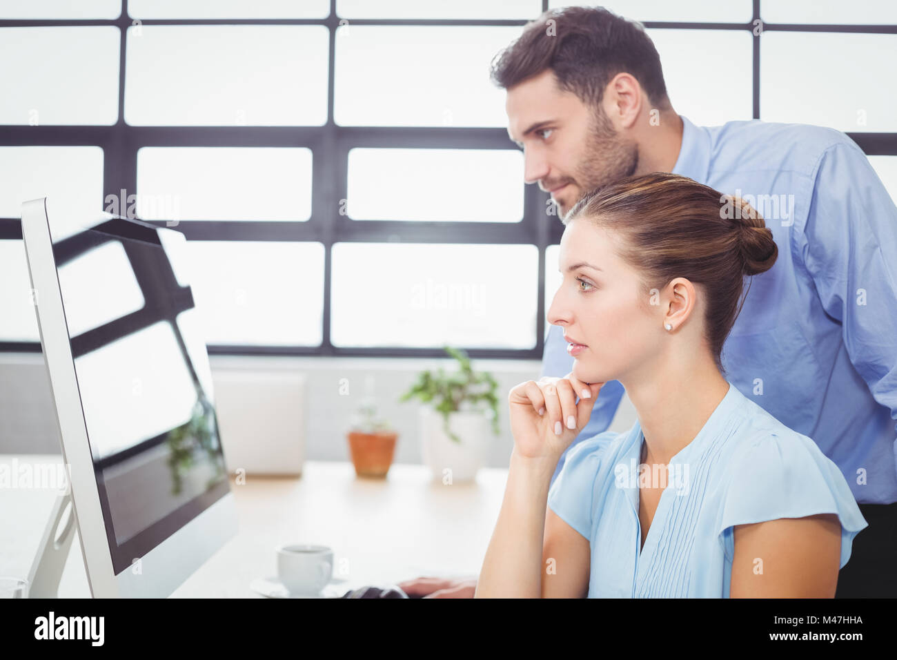 Concentrated business people looking at computer monitor Stock Photo ...