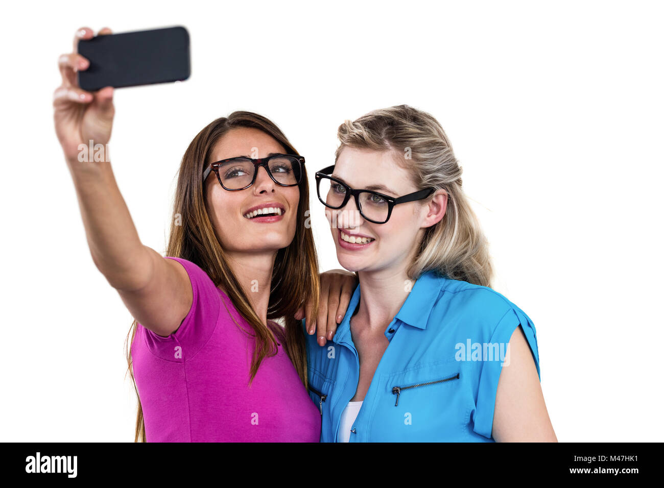 Smiling female friends taking self portrait with smartphone Stock Photo ...