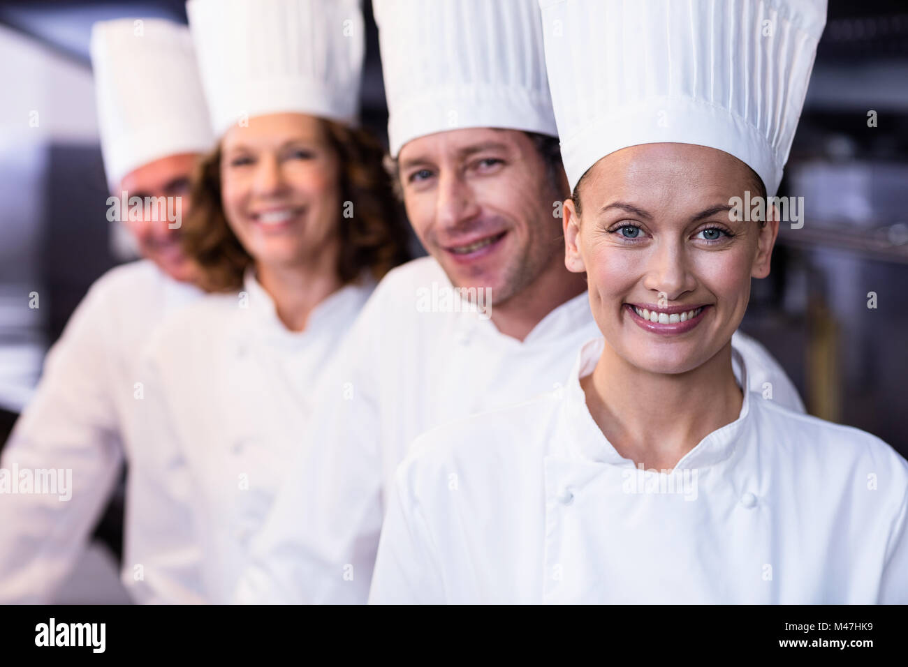 Happy chefs team standing together in commercial kitchen Stock Photo ...