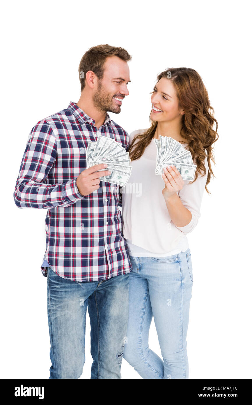 Happy young couple holding fanned out currency notes Stock Photo - Alamy