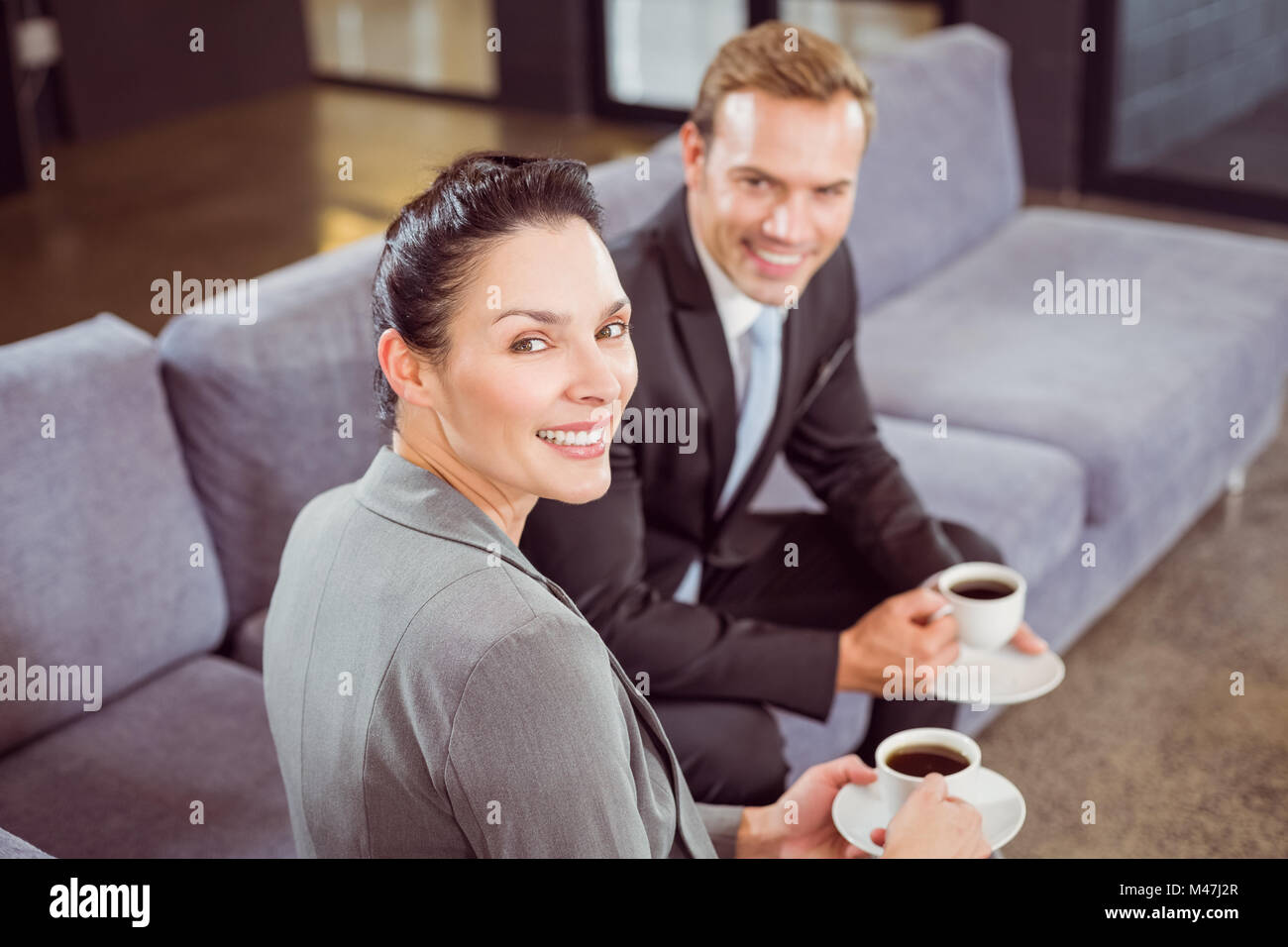 Businessman and businesswoman having tea during breaktime Stock Photo ...