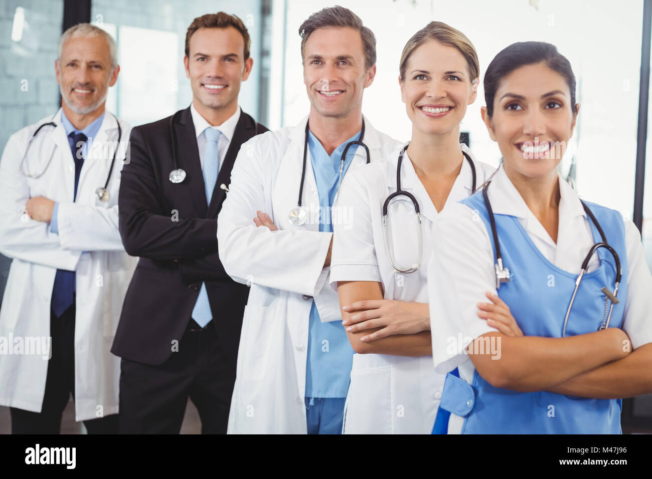 Happy medical team standing with arms crossed Stock Photo - Alamy