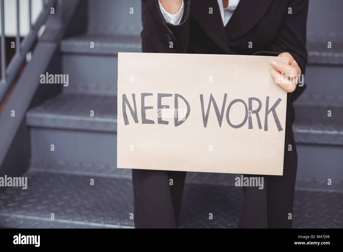 Midsection of unemployed businesswoman with need work placard Stock ...