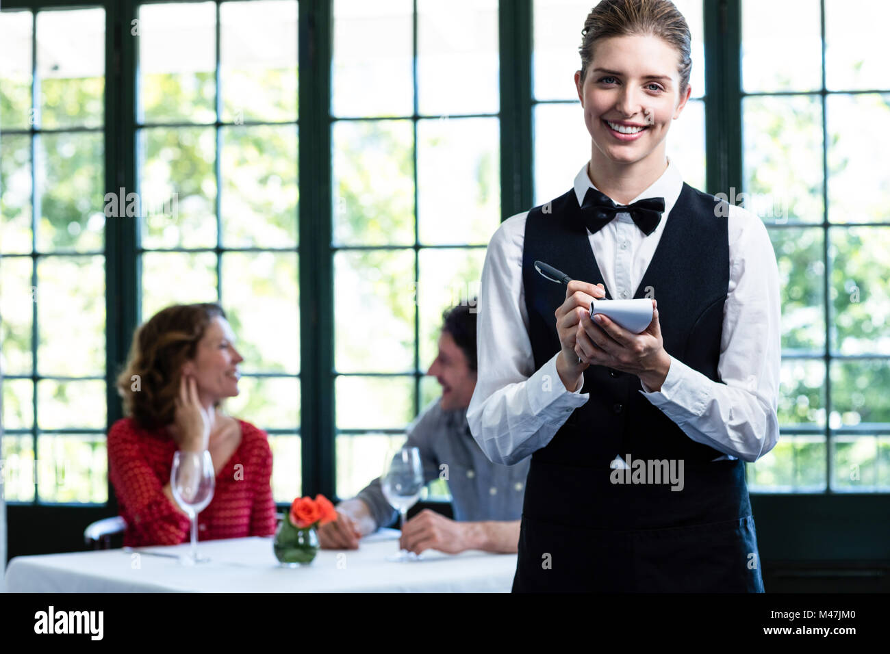 Portrait of beautiful waitress writing down an order Stock Photo - Alamy