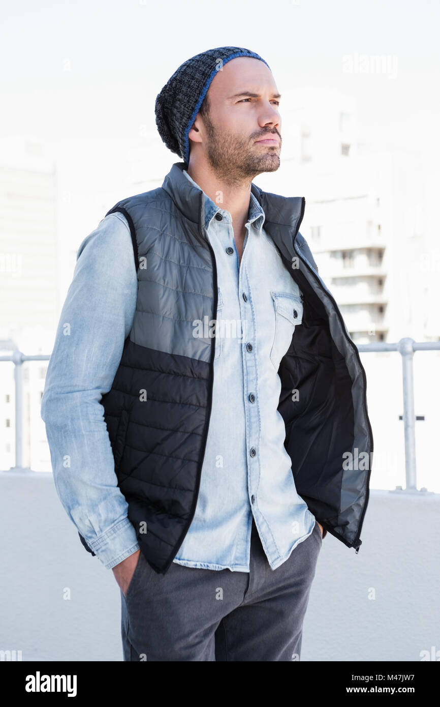 Confident young man wearing beanie hat and jacket Stock Photo - Alamy