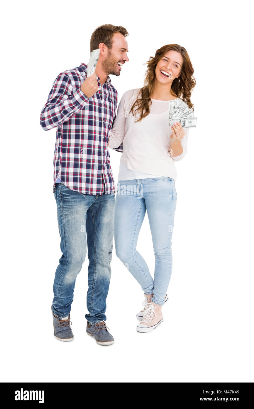 Happy young couple holding fanned out currency notes Stock Photo - Alamy