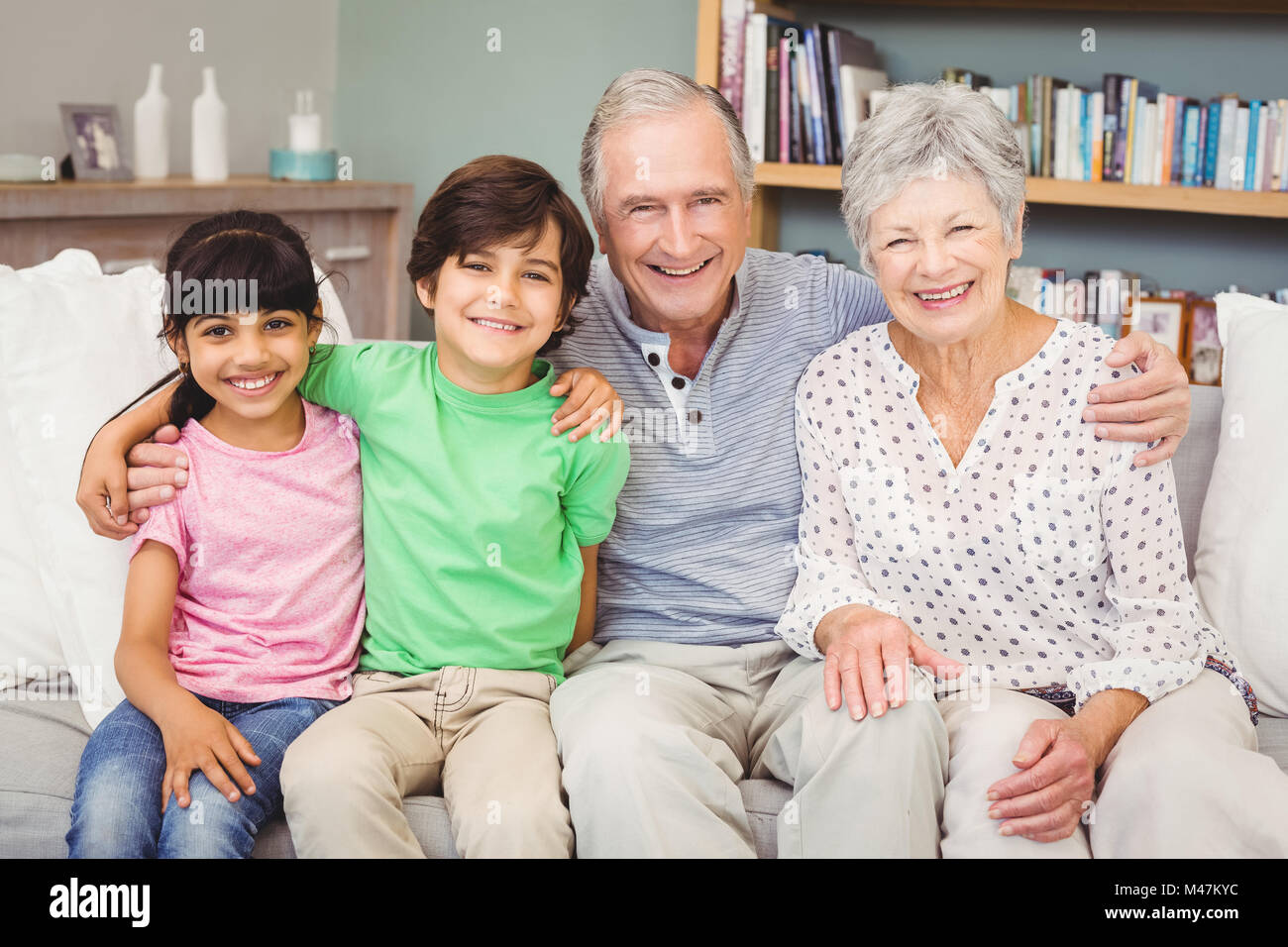 Portrait of happy grandchildren with grandparents at home Stock Photo ...