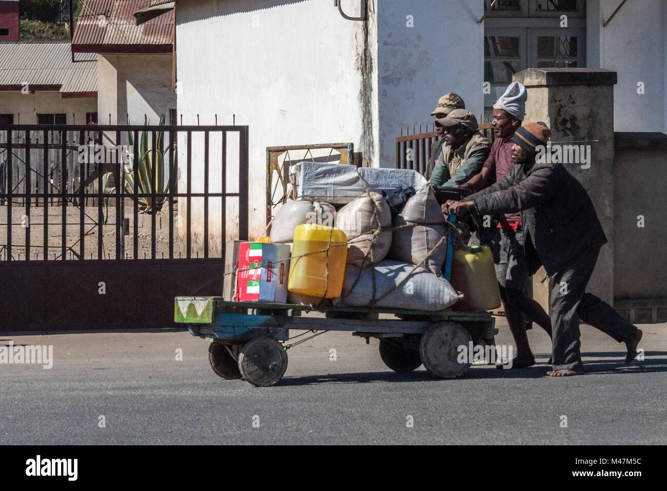 Pushing handcart hi-res stock photography and images - Alamy