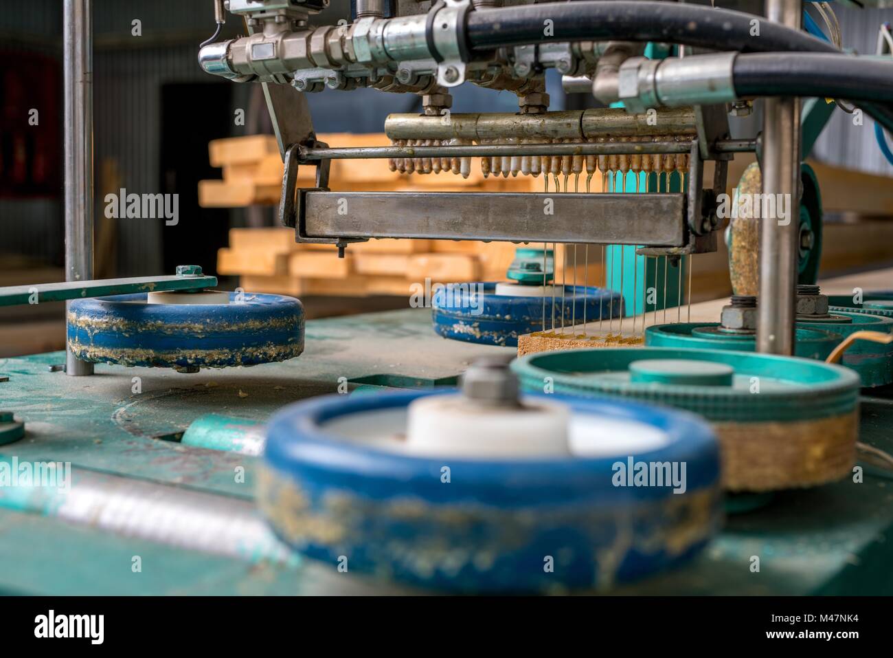 Machine for application of adhesive on lamella Stock Photo - Alamy