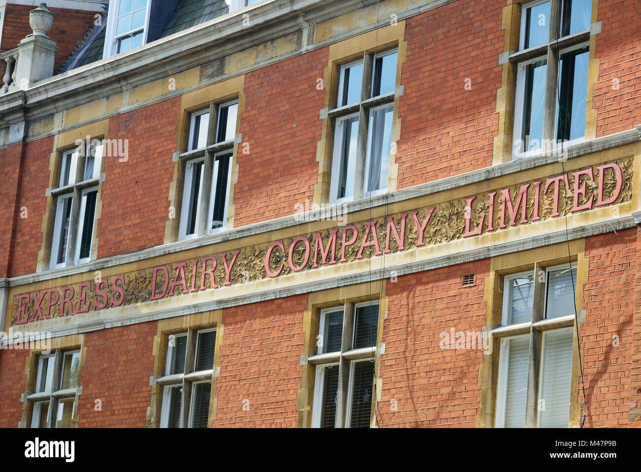 Frontage of red brick building with diary sign Stock Photo - Alamy