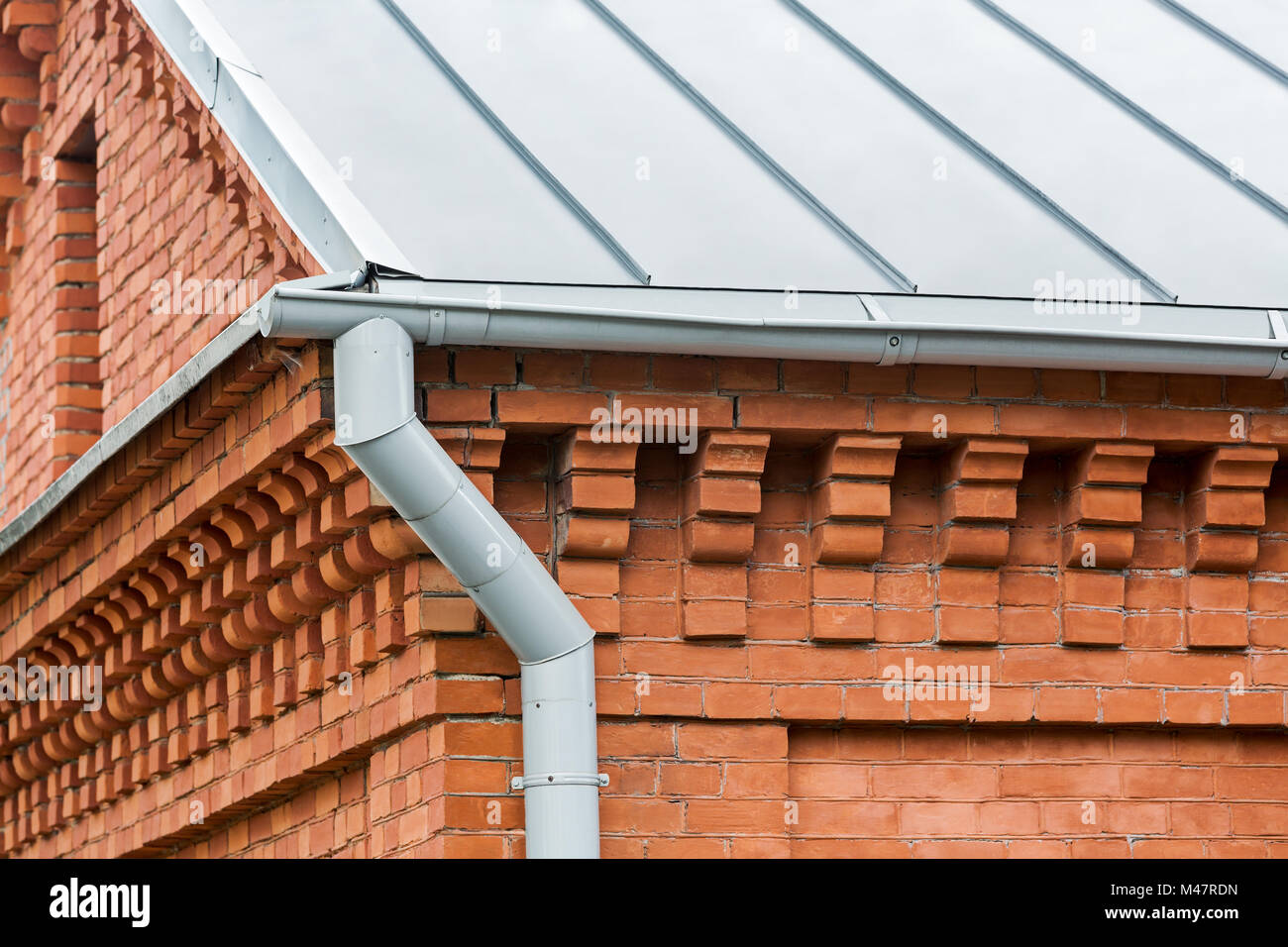 drainpipe with gutter on red brick wall Stock Photo - Alamy