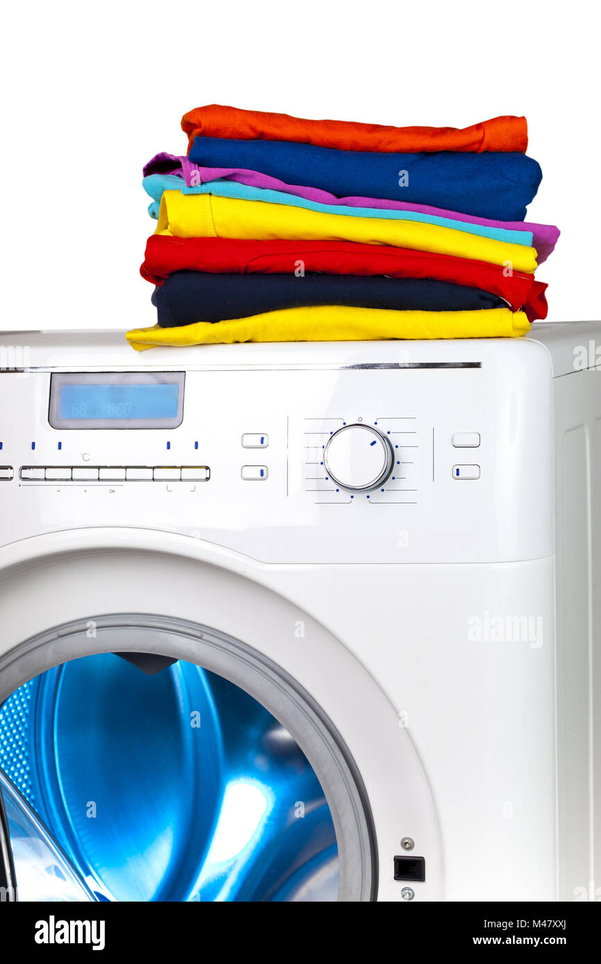Pile of colorful clothes on the washing machine Stock Photo - Alamy