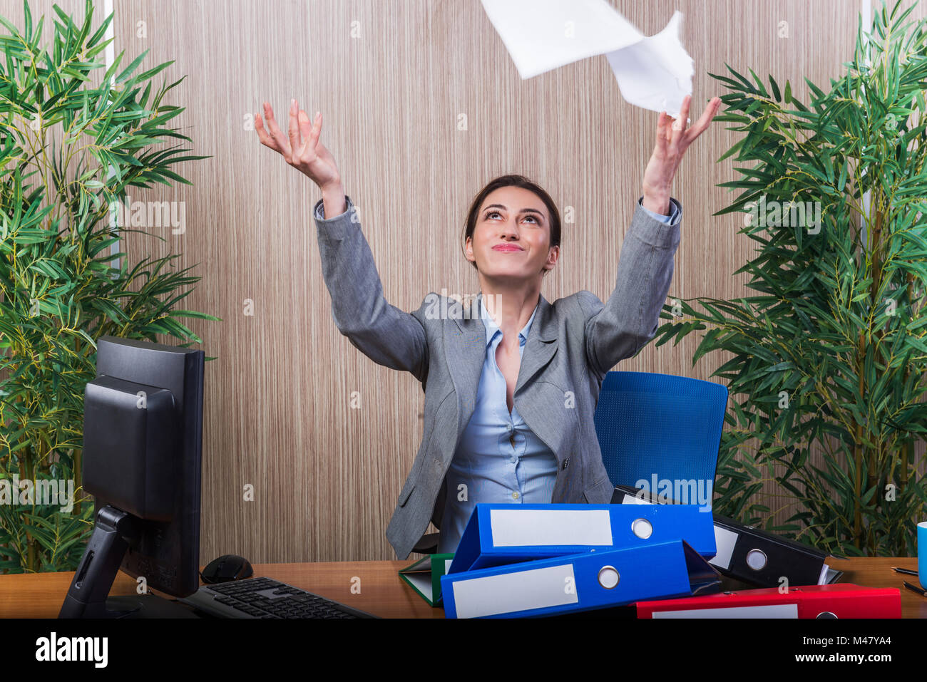 Woman throwing papers in the office under stress Stock Photo - Alamy