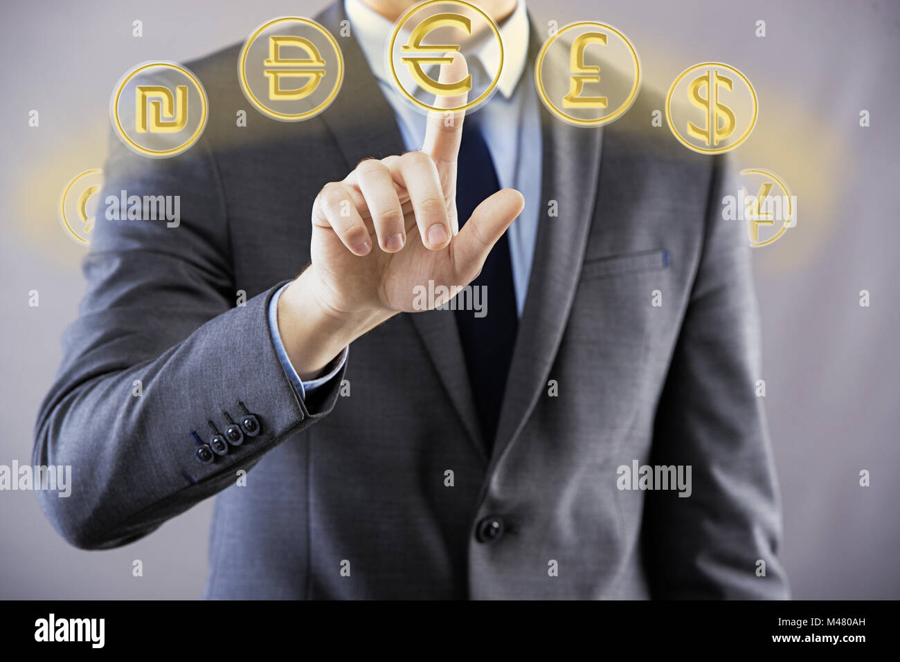 Man pressing buttons with different currencies Stock Photo - Alamy