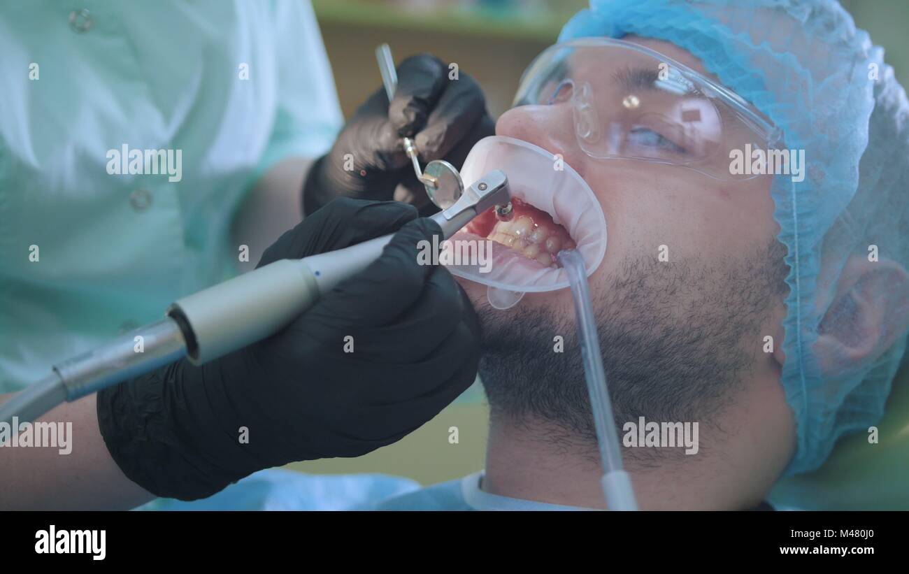 Doctor examining a patient with a retractor in the dental office Stock ...