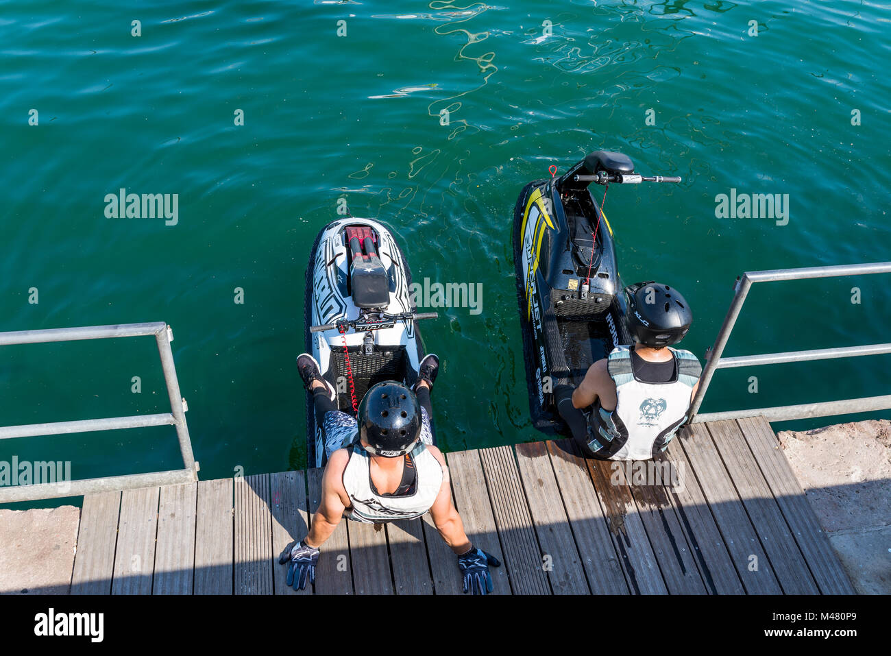 Two guys on jet boat in the harbor of Barcelona Stock Photo - Alamy