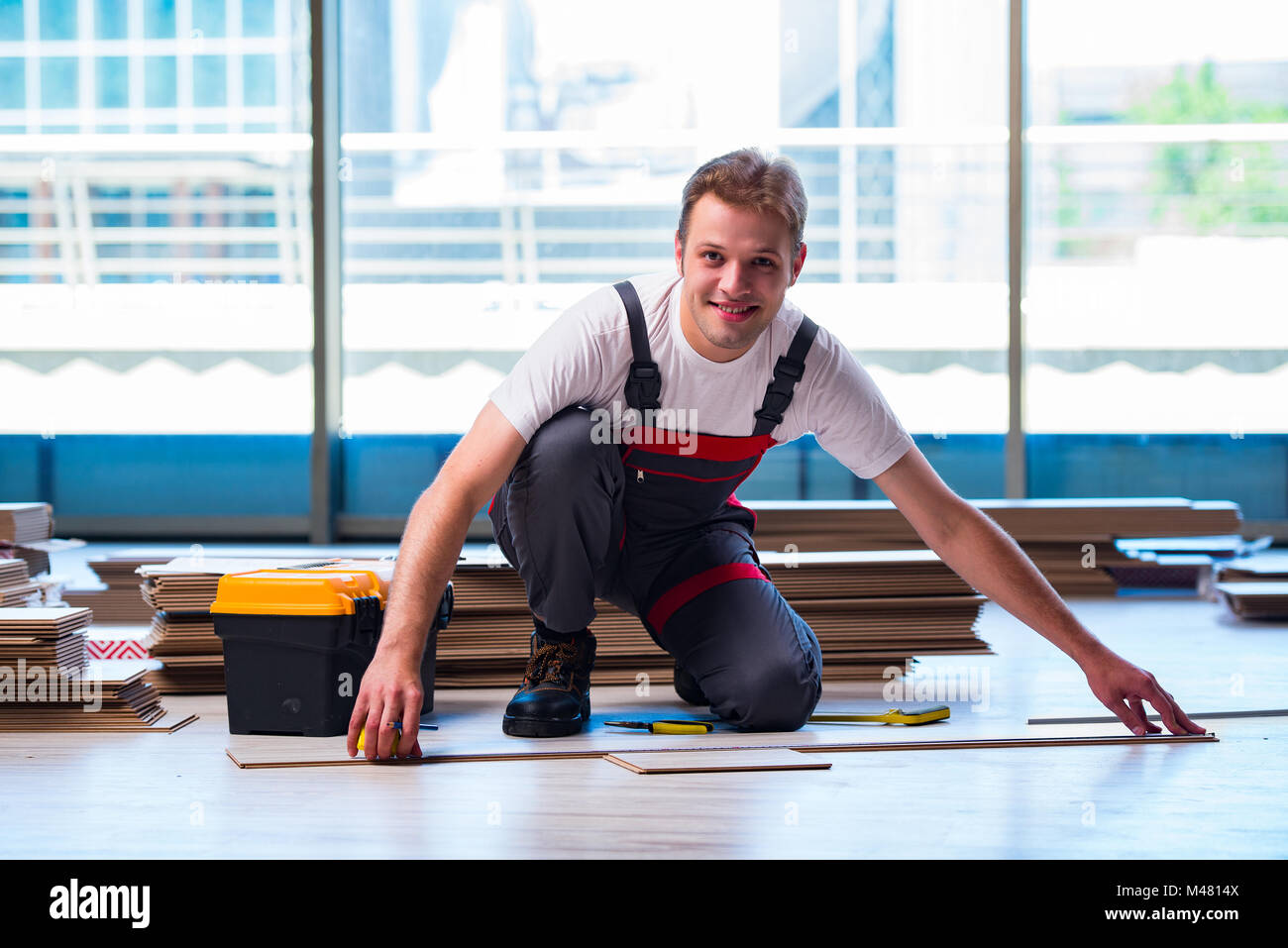 Man laying laminate flooring in construction concept Stock Photo - Alamy