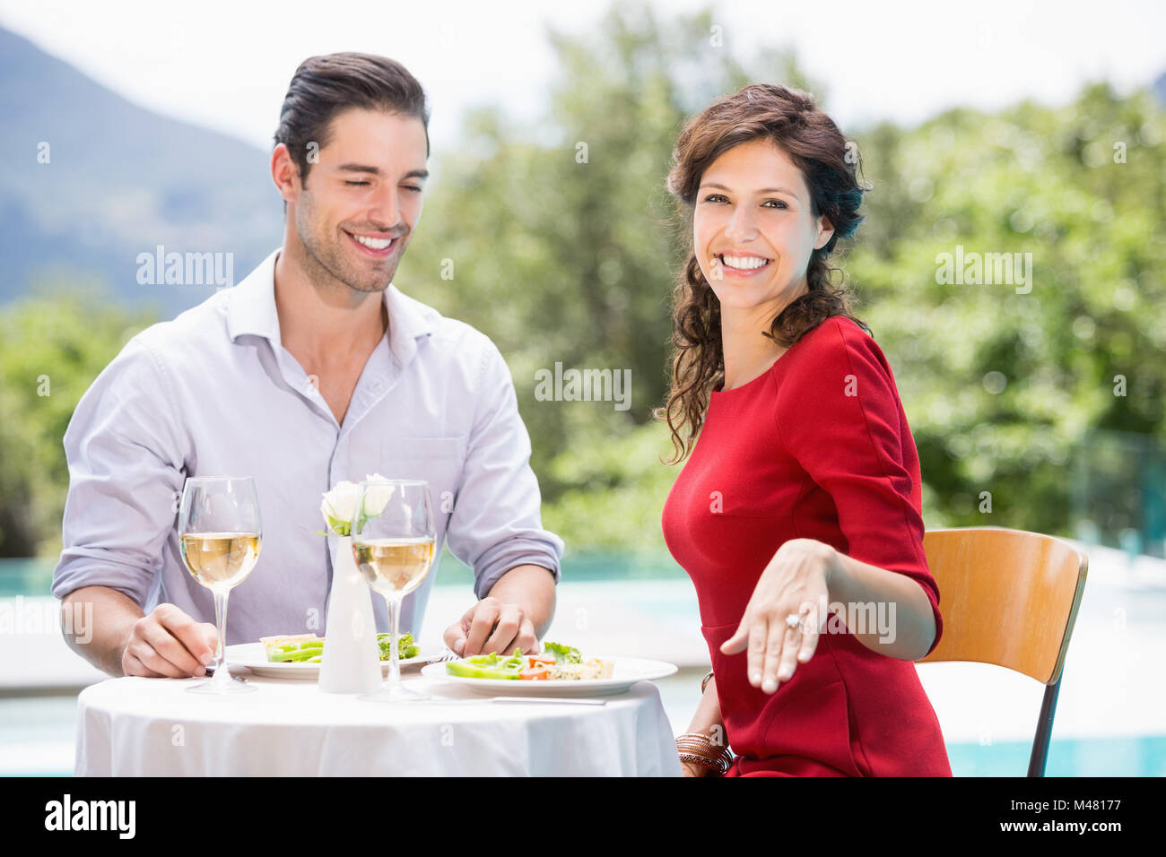 Portrait of smiling woman showing engagement ring Stock Photo - Alamy