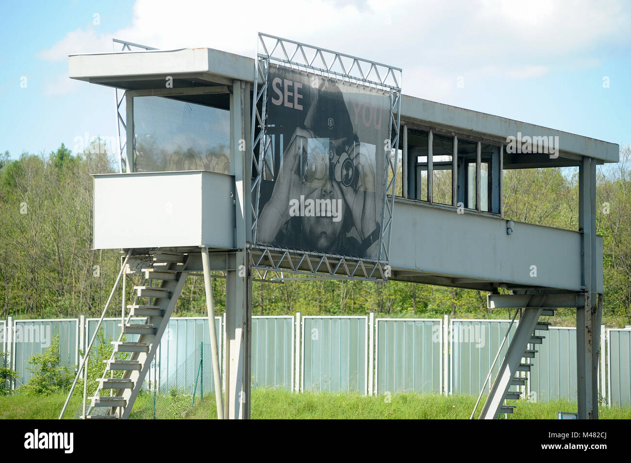 Observation bridge with picture of GDR border guard See you in former ...