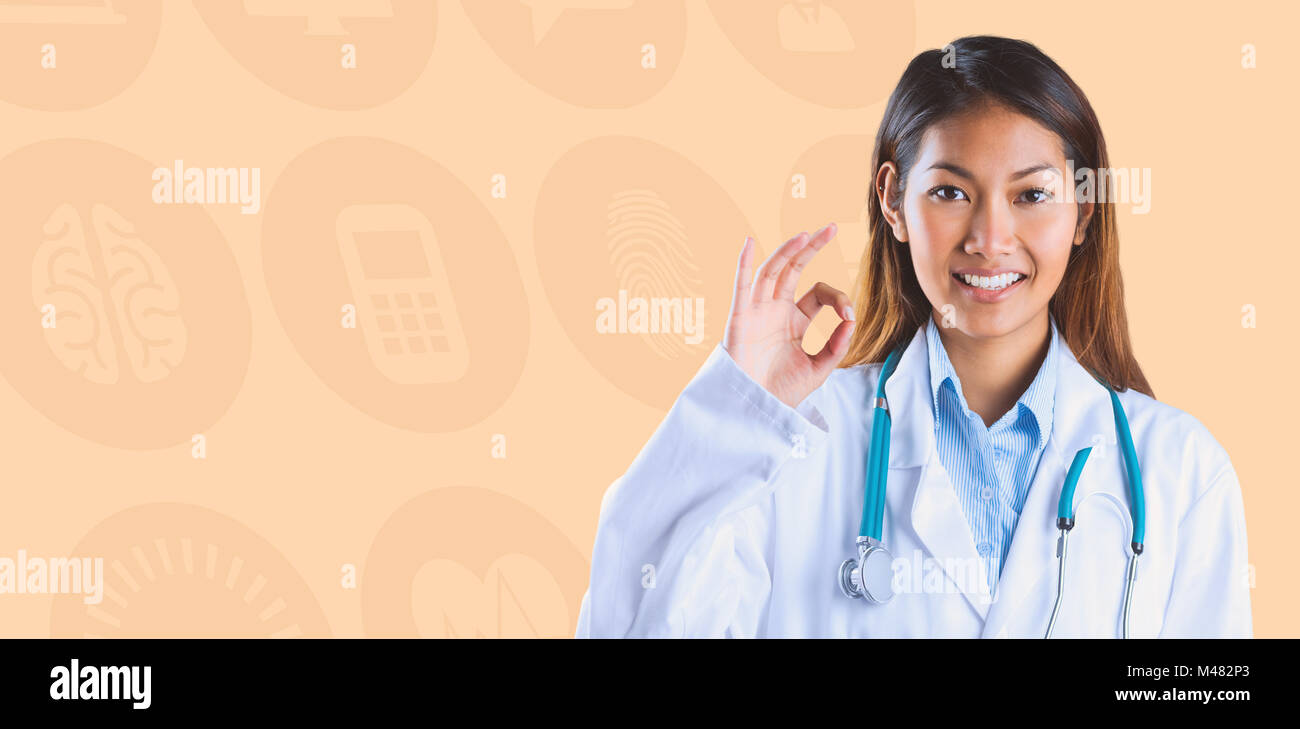 Composite image of asian doctor doing ok sign Stock Photo - Alamy