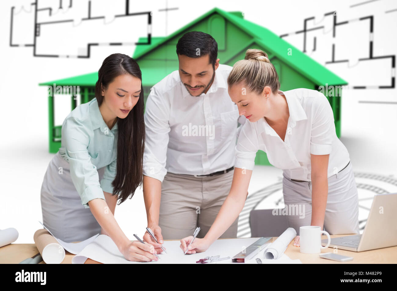 Composite image of architecture team working together at desk Stock ...