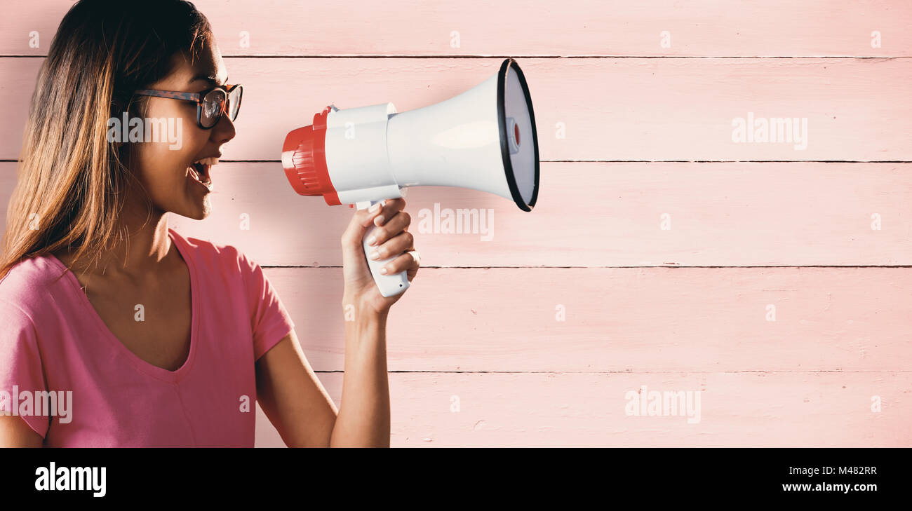 Composite image of asian woman shouting in megaphone Stock Photo - Alamy