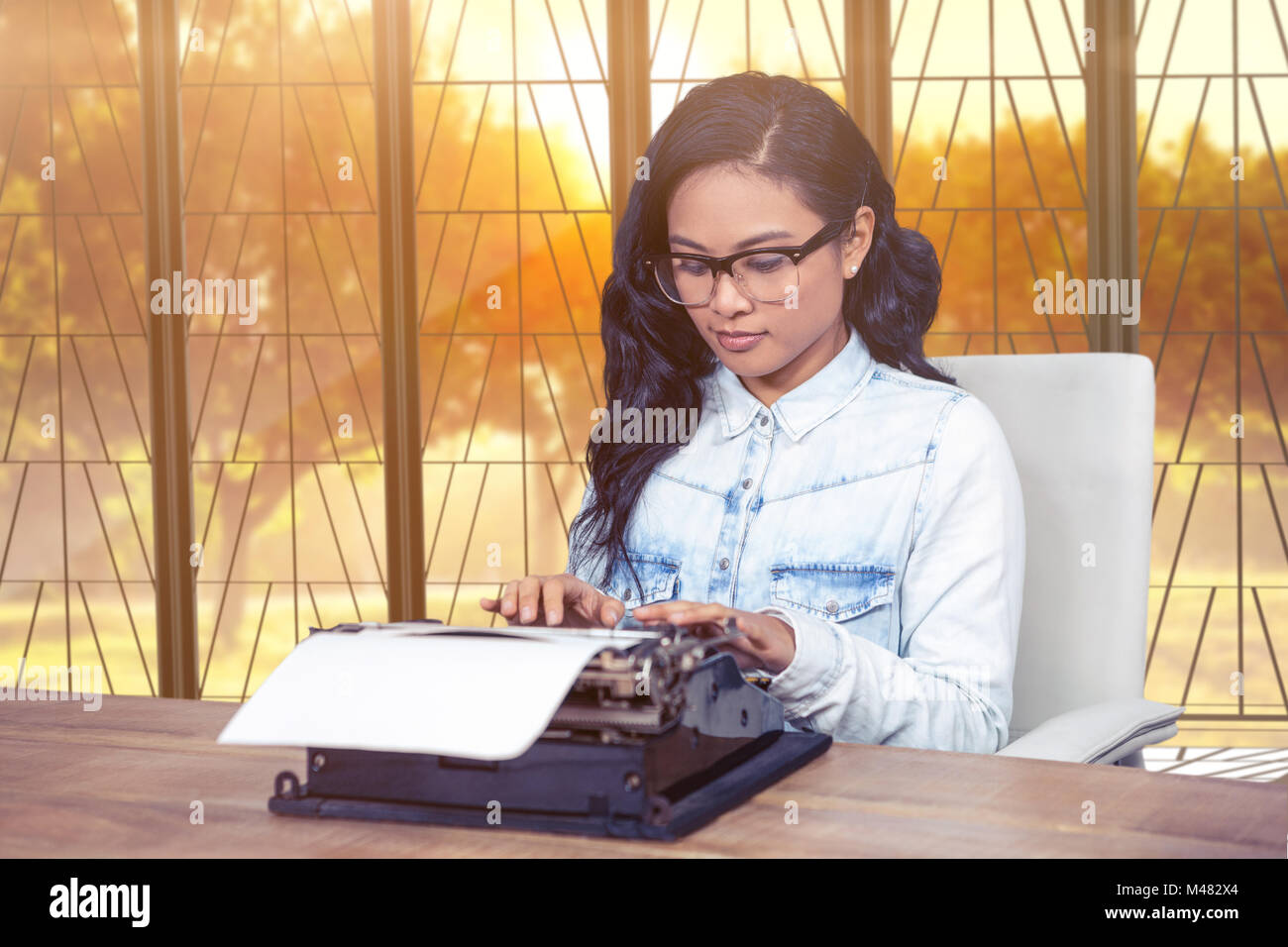 Composite image of asian woman typewriting Stock Photo - Alamy