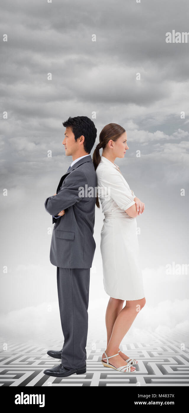 Composite image of portrait of serious business people standing back-to ...