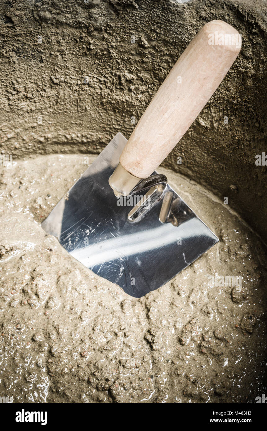 A bucket with a solution and a trowel, close-up Stock Photo - Alamy